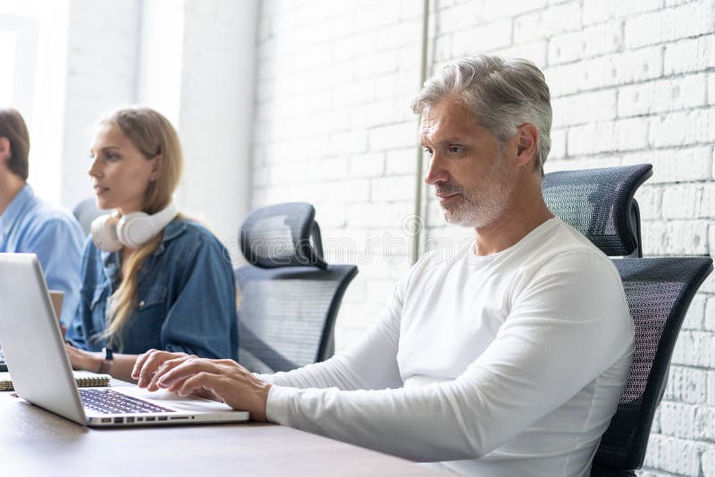 Man Working at Desk in Busy Creative Office. Stock Photo - Image of ...