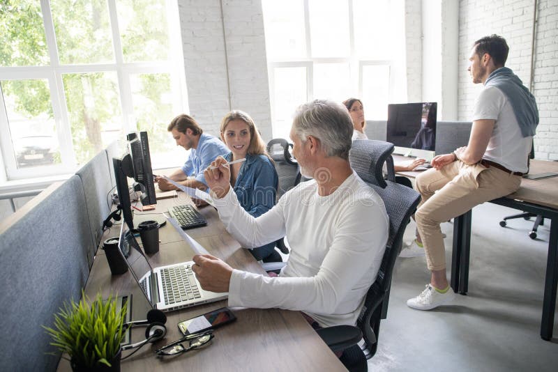 Man Working at Desk in Busy Creative Office. Stock Photo - Image of ...