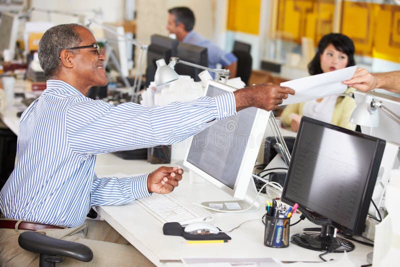 Man Working at Desk in Busy Creative Office Stock Photo - Image of ...