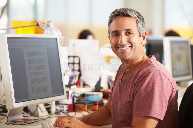 Man Working at Desk in Busy Creative Office Stock Image - Image of ...