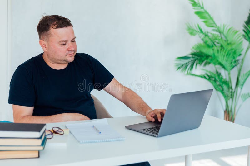Man Working at Desk with Laptop in White Office Stock Image - Image of ...