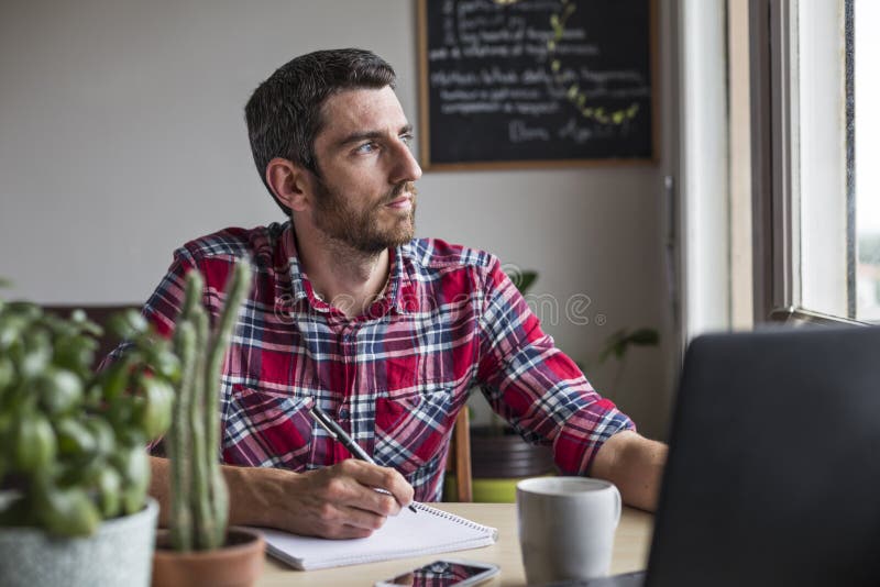 Man Working at Desk Thinking about Ideas and Looking Out of Window ...