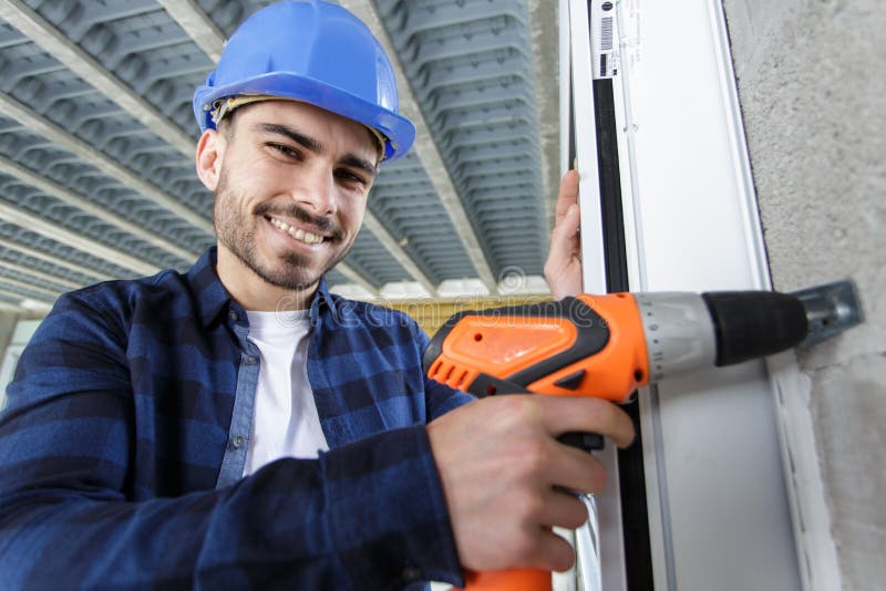 Man working with drill stock photo. Image of renovation - 254759458