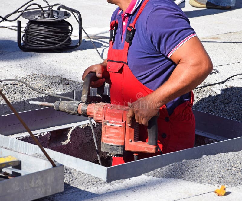 Man is Working with a Drill at the Construction Site Stock Photo ...