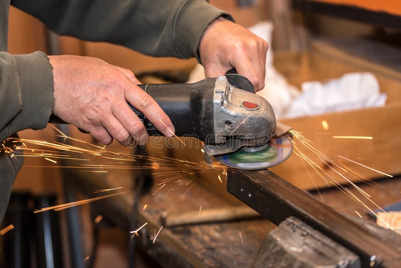 Man Working with Electric Grinder Tool on Steel Stock Photo - Image of ...
