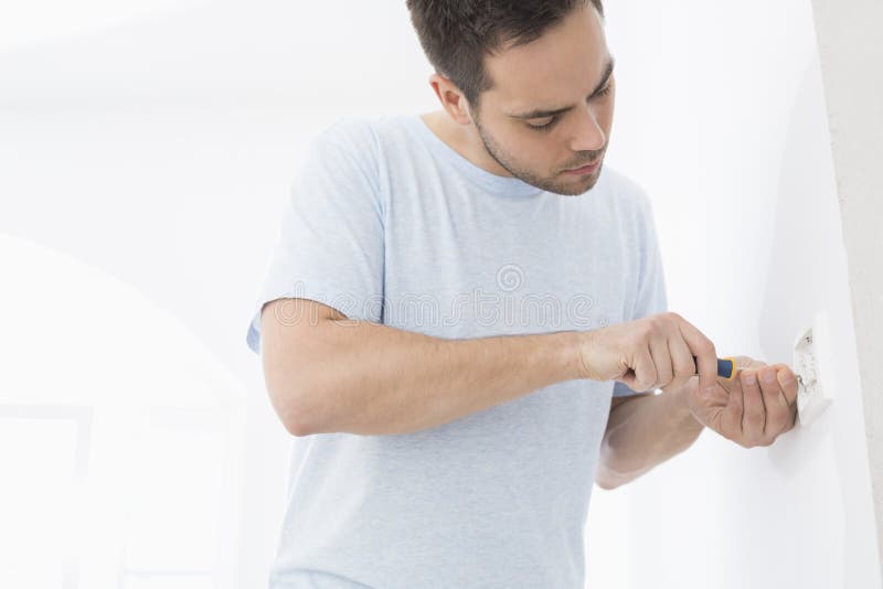 Man Working on Electrical Outlet Stock Image - Image of looking, home ...
