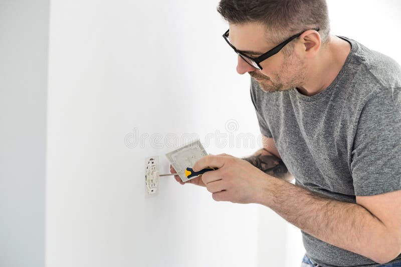 Man Working on Electrical Outlet Stock Image - Image of people, indoors ...