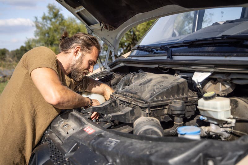 Man Working in the Engine Compartment of a Van Outdoors Stock Image ...