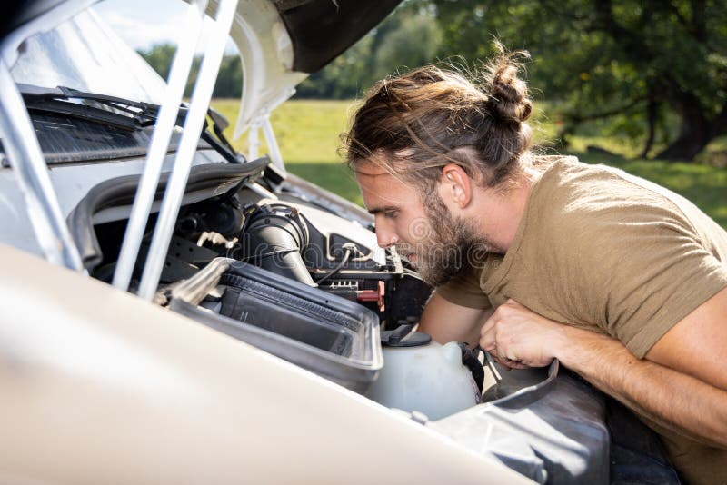 Man Working Inside the Engine Compartment of a Van Outdoors Stock Image ...