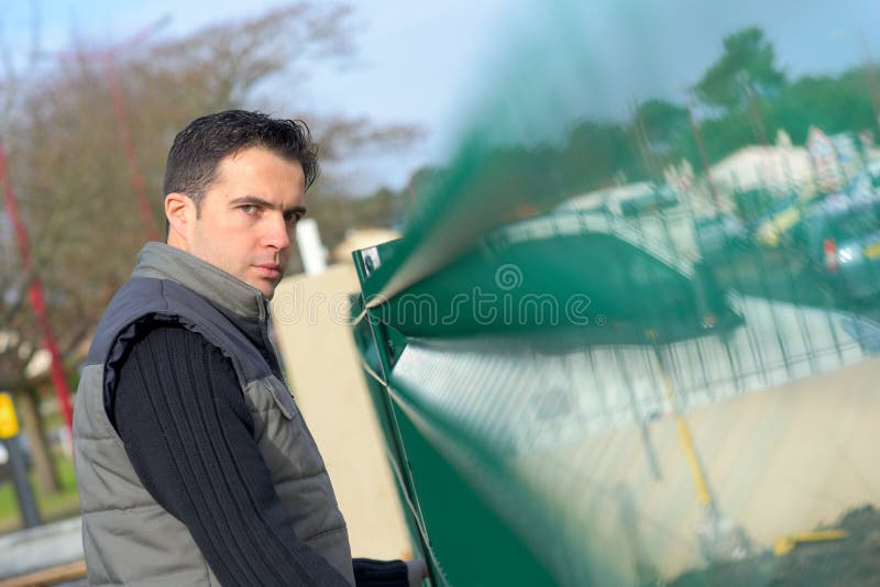 Man working on fence stock photo. Image of homework - 261515888