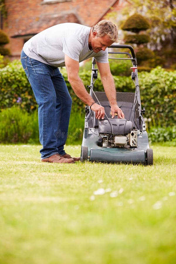 Man Working in Garden Cutting Grass with Lawn Mower Stock Image - Image ...