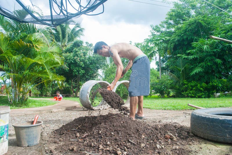 The Man Working in the Garden with the Help of a Shovel Digging Stock ...