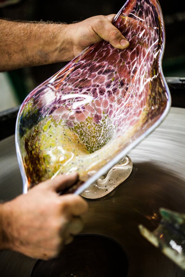Man Working a Glass Blown Vase on Spinning Silica Sanding Disk Stock ...