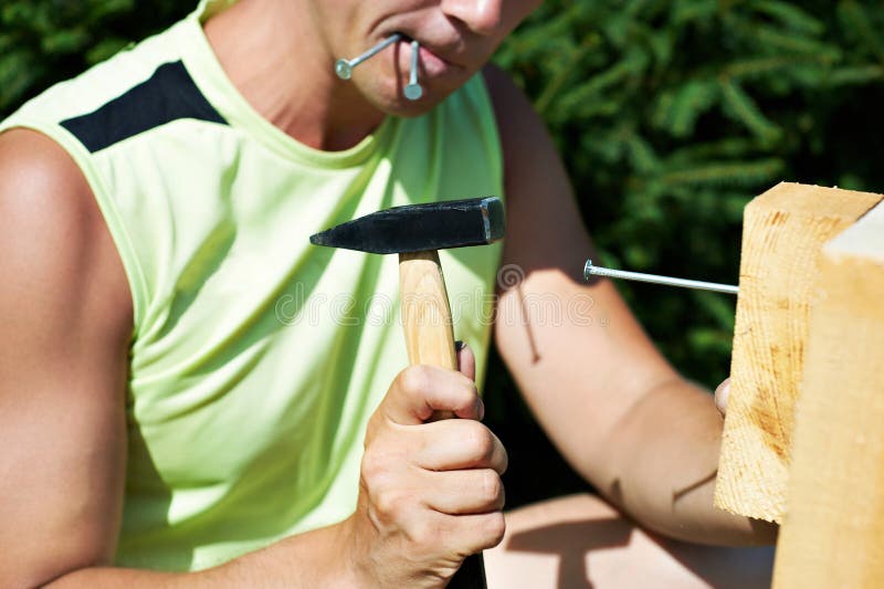 Man working with a hammer stock photo. Image of wooden - 27400044