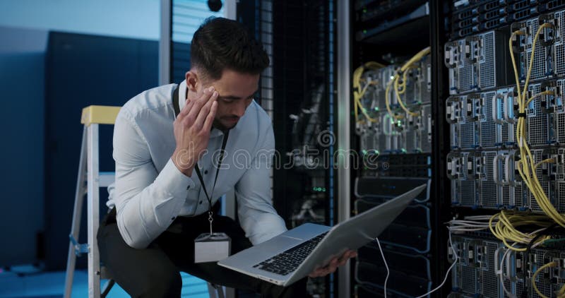Man Working And Headache From Programming With Data On Pc In Server Room Or Technician With