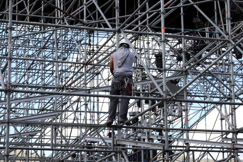 Man Working at Height Assembling a Stage Structure. Construction Worke ...