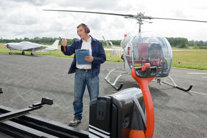 Man Working with Helicopter Stock Image - Image of standing, stand ...
