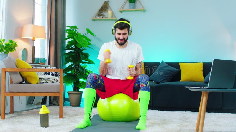 A Man Working on His Biceps is Very Happy with Himself, he is Smiling a ...