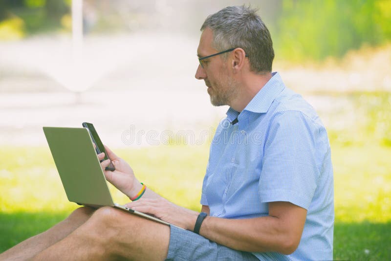 Man Working on His Laptop in the Park Stock Image - Image of blue, male ...