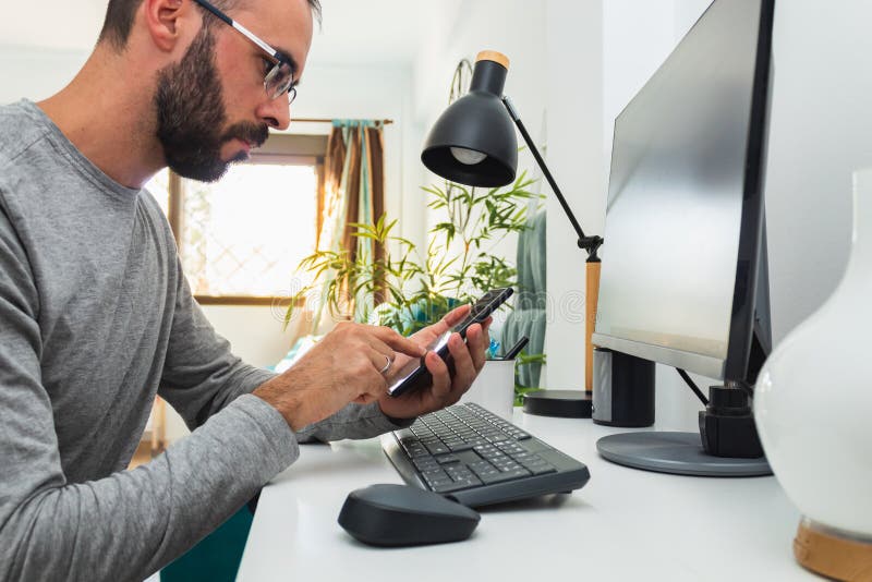 Man Working from Home with Computer and Mobile Phone Stock Image ...