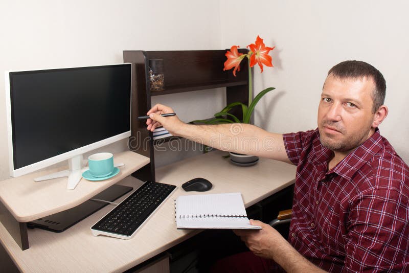 Man Working at Home at the Computer Takes Notes Stock Photo - Image of ...