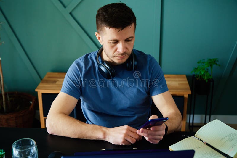 Bored Man Playing Smartphone while Working at Home Office Stock Image ...