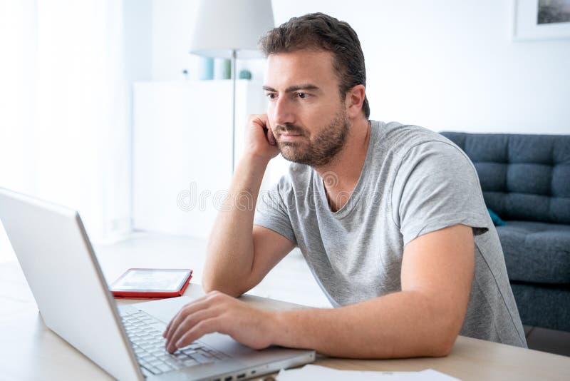 Man Working from Home Using Computer and Internet Connection Stock ...