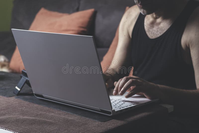 Man Working from Home Using a Laptop while Sitting on the Couch Stock ...