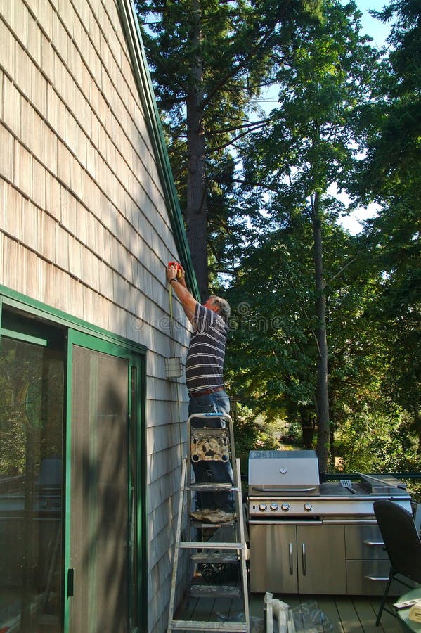 Man working on house stock photo. Image of tape, improving - 1235406