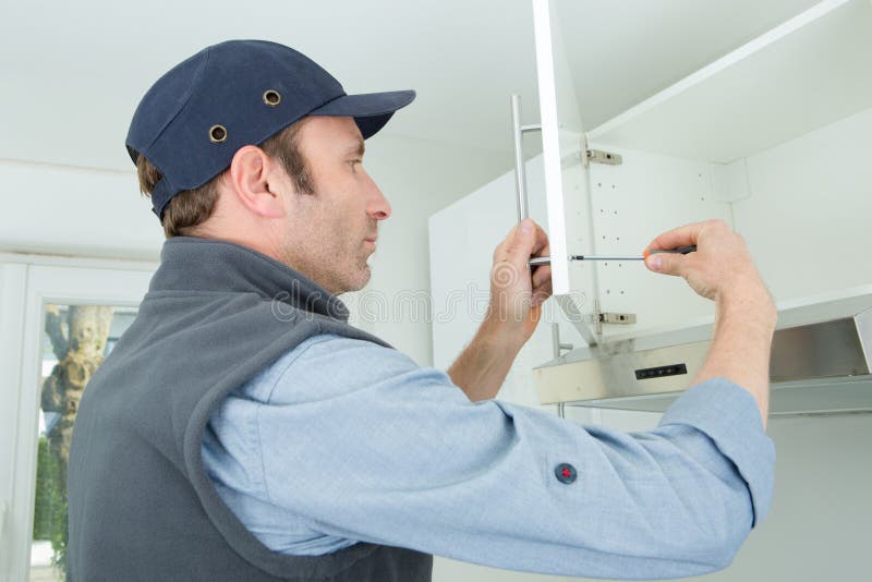 Man Working on Kitchen Cupboard Stock Photo - Image of occupation ...