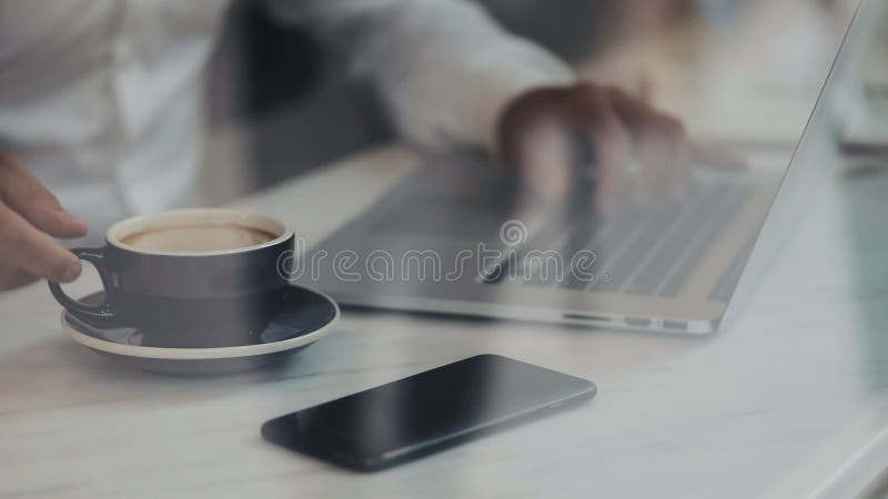 Man Working on Laptop in Cafe. Young Freelancer is Sitting in Cafeteria ...