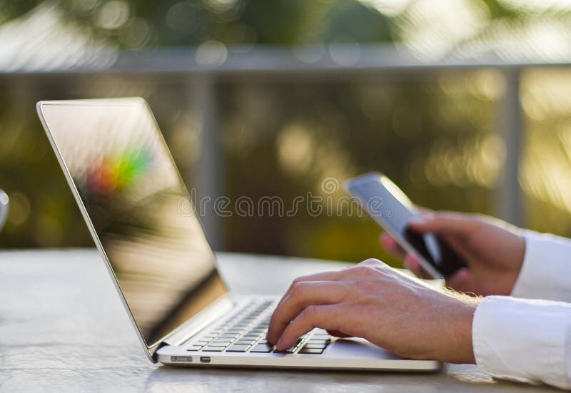 Man Working with Laptop and Cell Phone Stock Photo - Image of desktop ...