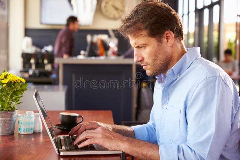 Man Working on Laptop in a Coffee Shop Stock Image - Image of focus ...