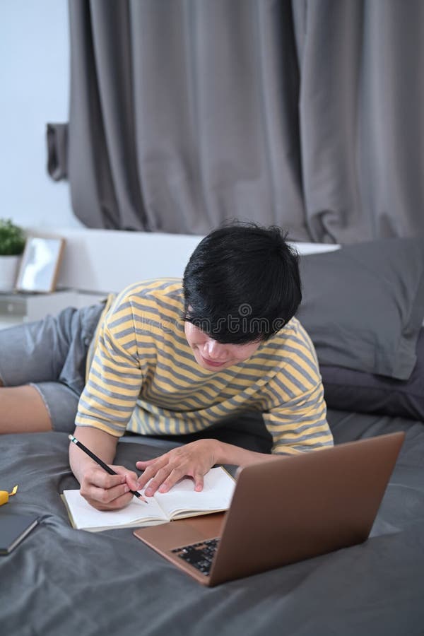 Man Working Laptop Computer on His Bed. Stock Image - Image of ...