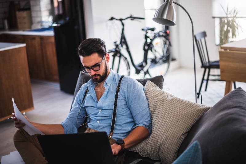 Man Working on Laptop Computer while Sitting on Sofa Stock Photo ...