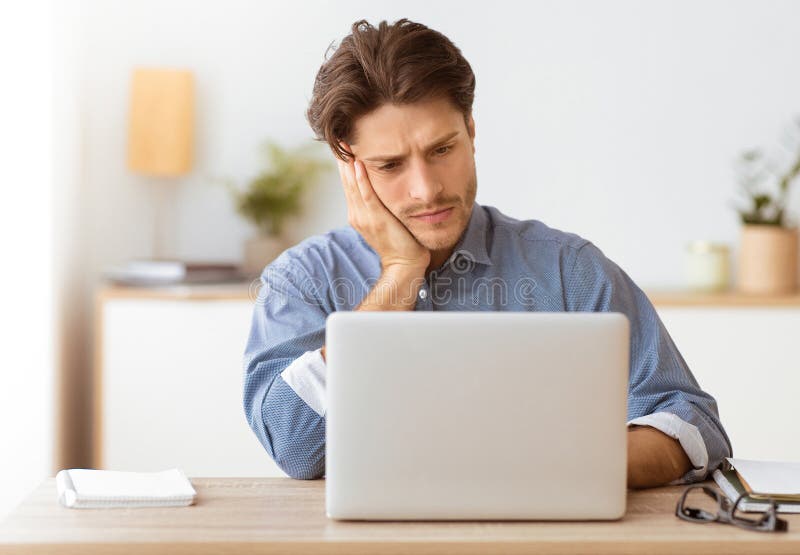 Man Working on Laptop with Concerned Expression Stock Image - Image of ...