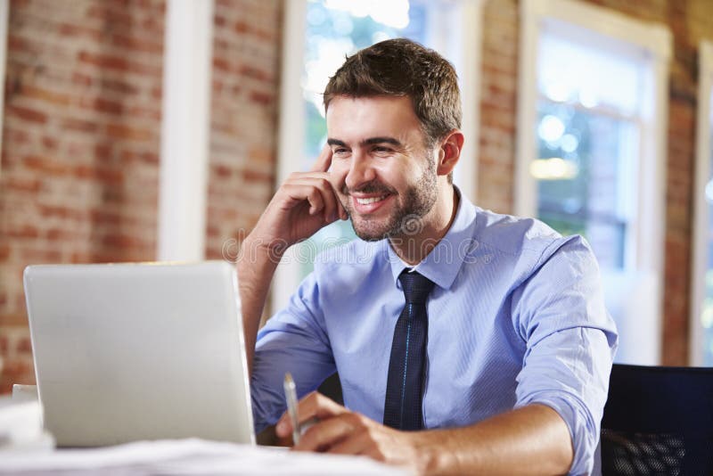 Man Working at Laptop in Contemporary Office Stock Image - Image of ...