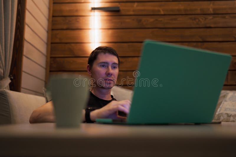 Man Working on Laptop in Cozy Home Setting Stock Photo - Image of home ...