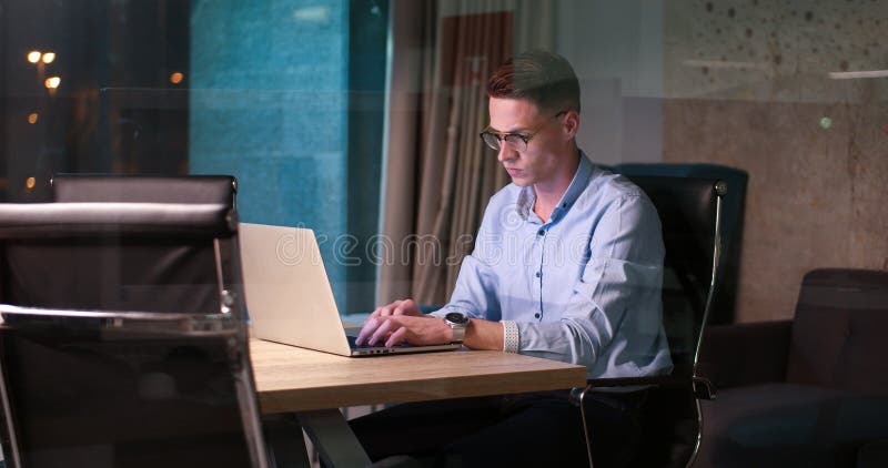 Man Working on Laptop in Dark Office Stock Photo - Image of dark ...