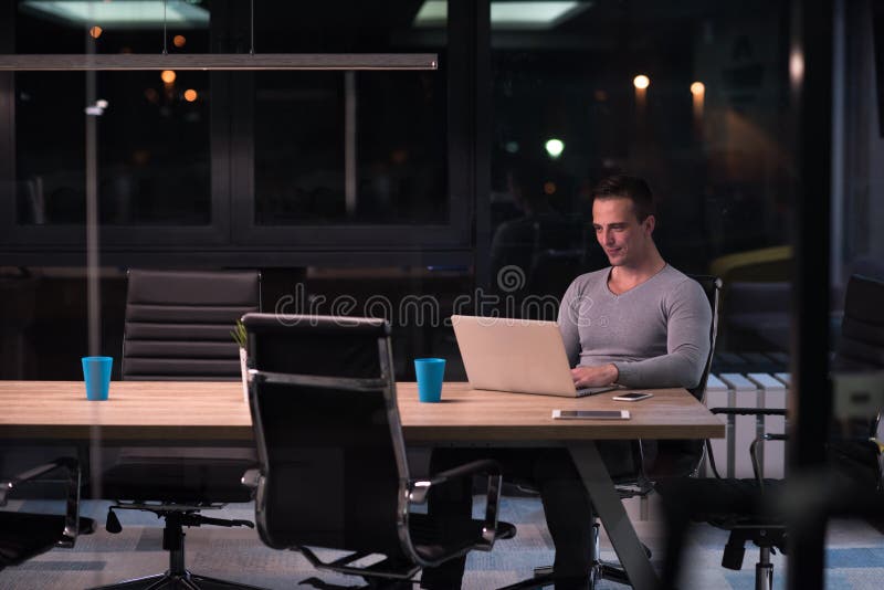 Man Working on Laptop in Dark Office Stock Image - Image of designer ...