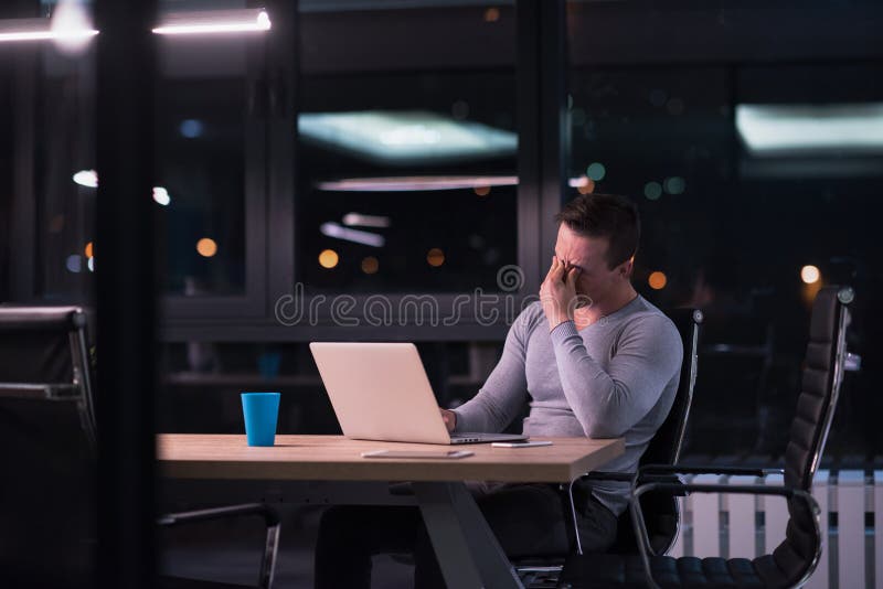 Man Working on Laptop in Dark Office Stock Photo - Image of desktop ...