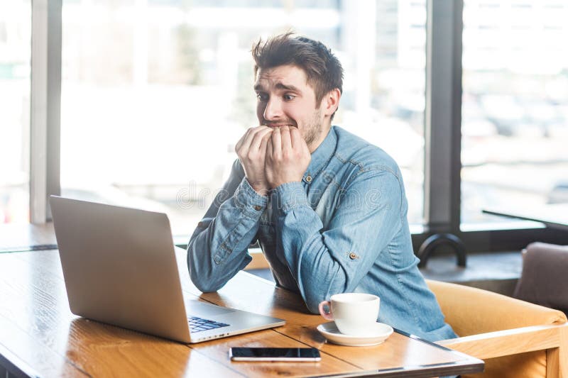 Man Working on Laptop, Looking at Display, Biting His Finger Nails ...