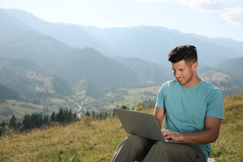 Man Working with Laptop in Mountains on Sunny Day Stock Photo - Image ...