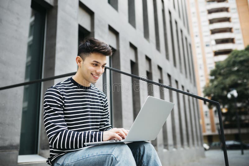 Man Working on a Laptop at the Street Stock Photo - Image of clothing ...