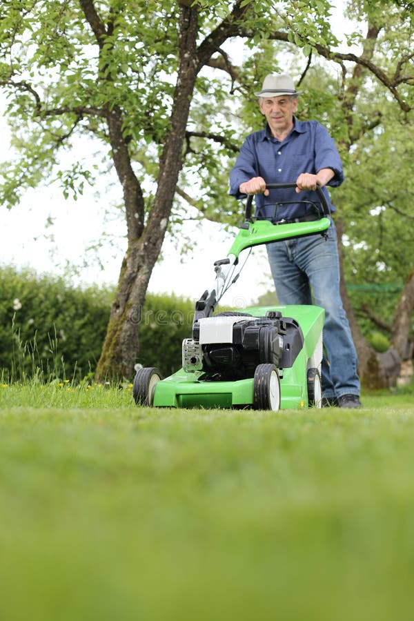 Man Working with a Lawn Mower in His Garden Stock Photo - Image of ...