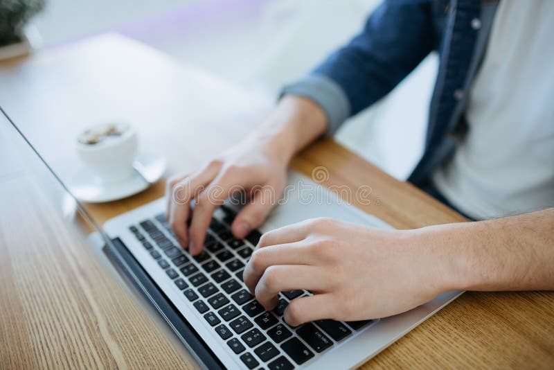 Man Working on a Macbook or Laptop in Cafe Stock Photo - Image of jeans ...