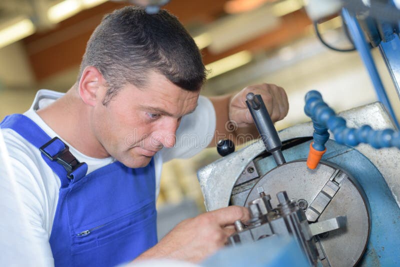Man working on machine stock image. Image of factory - 90835179