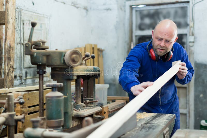 Man Working on a Machine at Wood Workshop Stock Photo - Image of hold ...