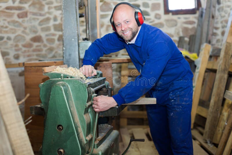 Man Working on a Machine at Workshop Stock Photo - Image of happiness ...