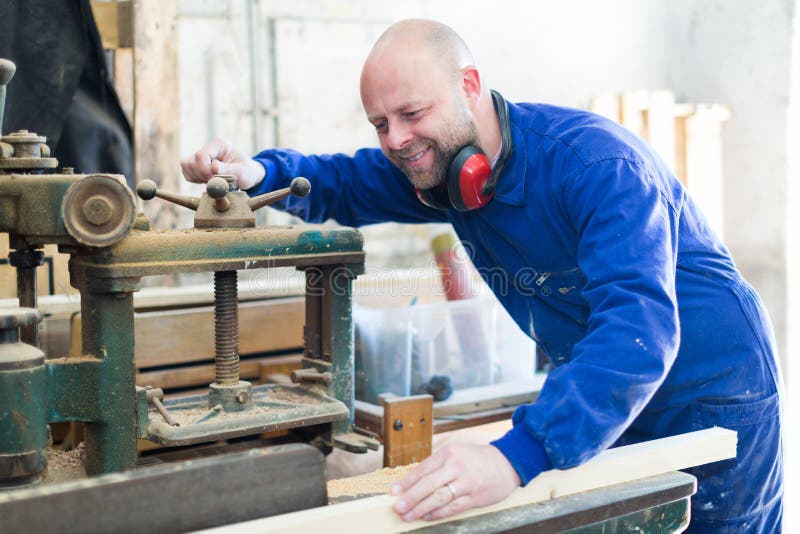 Man Working on a Machine at Workshop Stock Photo - Image of building ...